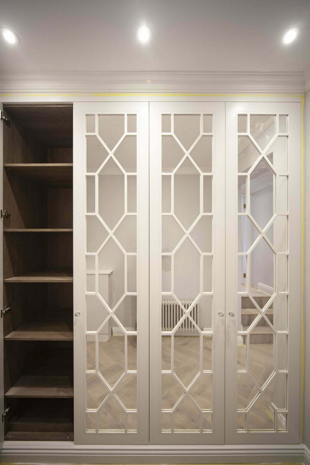 Prisma fitted mirrored wardrobes with lacquered fretwork doors London