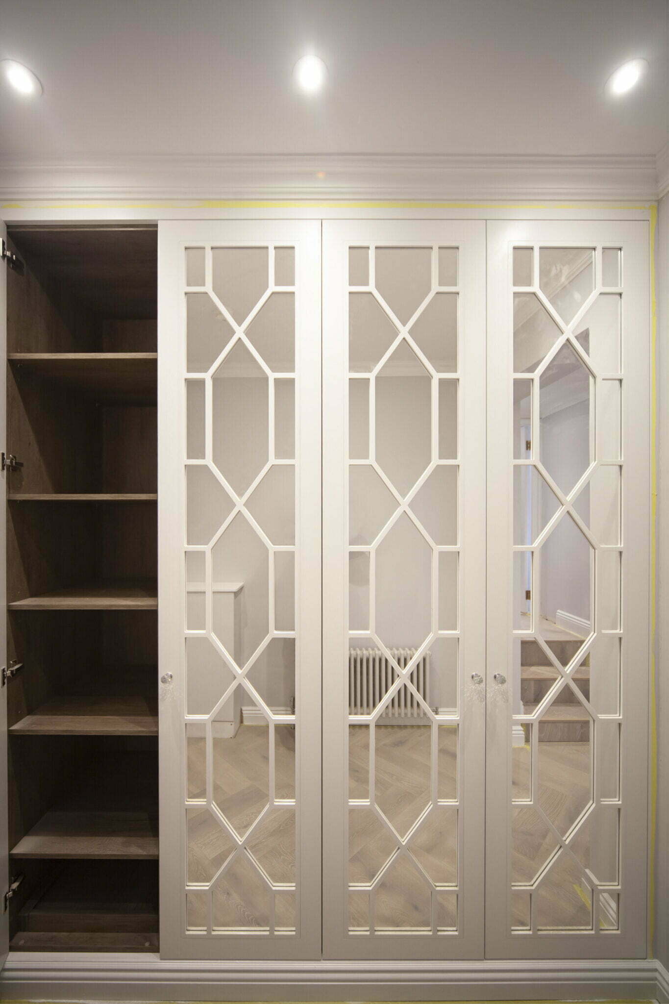 Prisma fitted mirrored wardrobes with lacquered fretwork doors London
