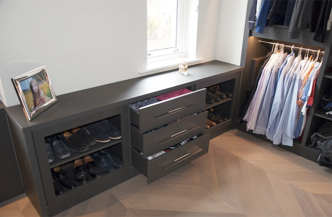 Dark wood walk in wardrobe with leather and LED lighting, London