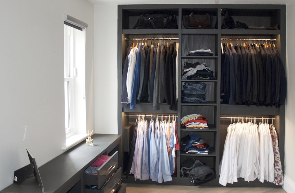 Dark wood walk in wardrobe with leather and LED lighting, London