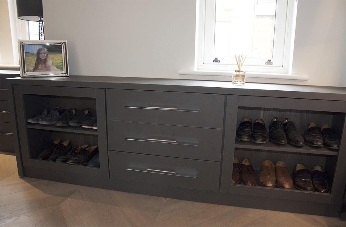 Dark wood walk in wardrobe with leather and LED lighting, London