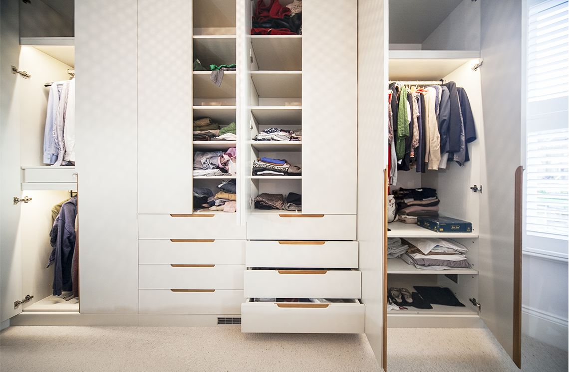 Scandi range wardrobe with external drawers built around chimney breast