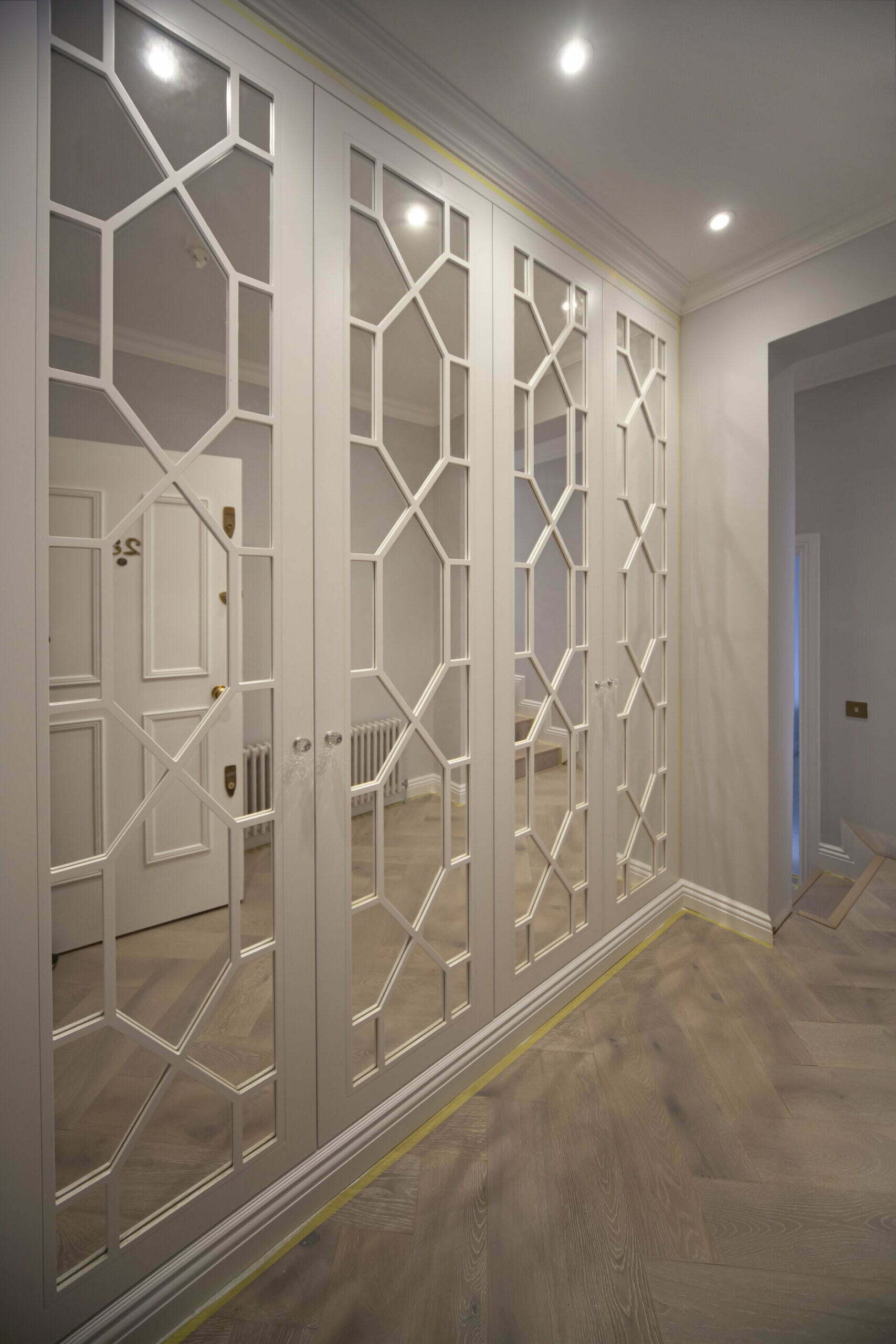 Prisma fitted mirrored wardrobes with lacquered fretwork doors London
